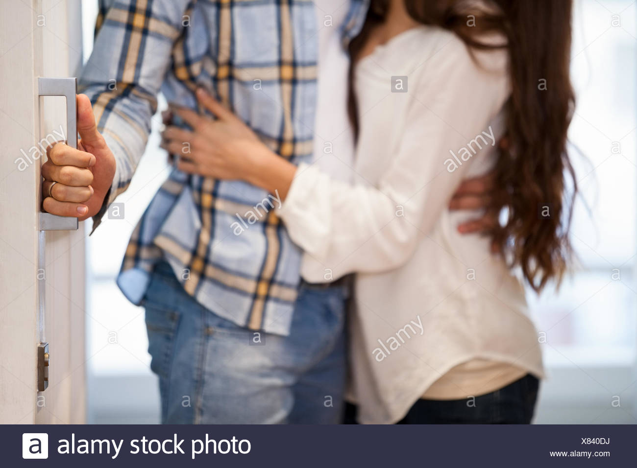 Young Man Opening Front Door Of House Stock Photos & Young Man Opening ...
