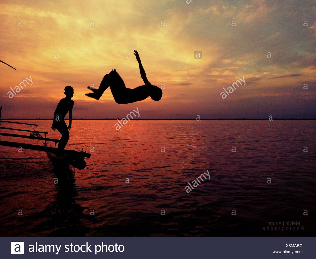 Children Jumping Into Water Silhouette High Resolution Stock ...