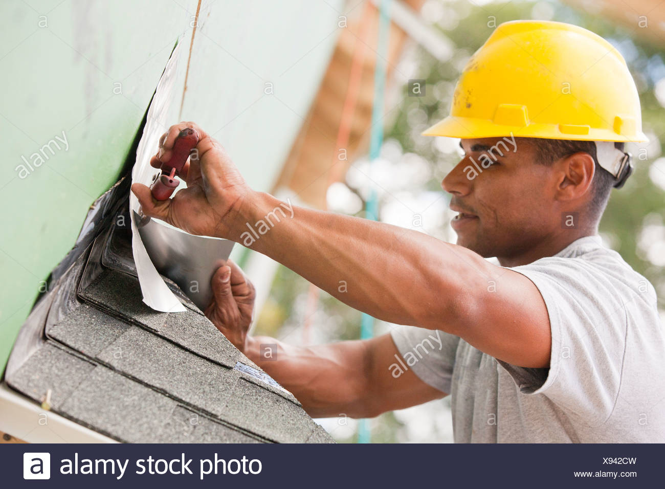 Man Working On House Roof High Resolution Stock Photography and Images ...
