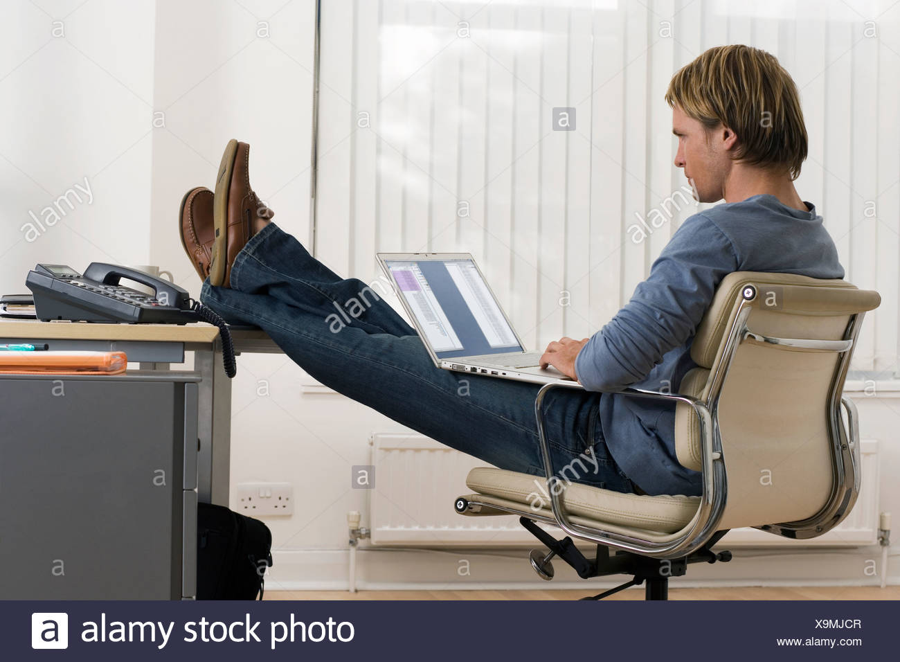 Feet Up On Desk Stock Photos & Feet Up On Desk Stock Images - Alamy