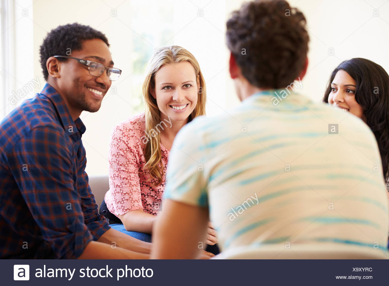 Four People Sitting On Chairs High Resolution Stock Photography and ...
