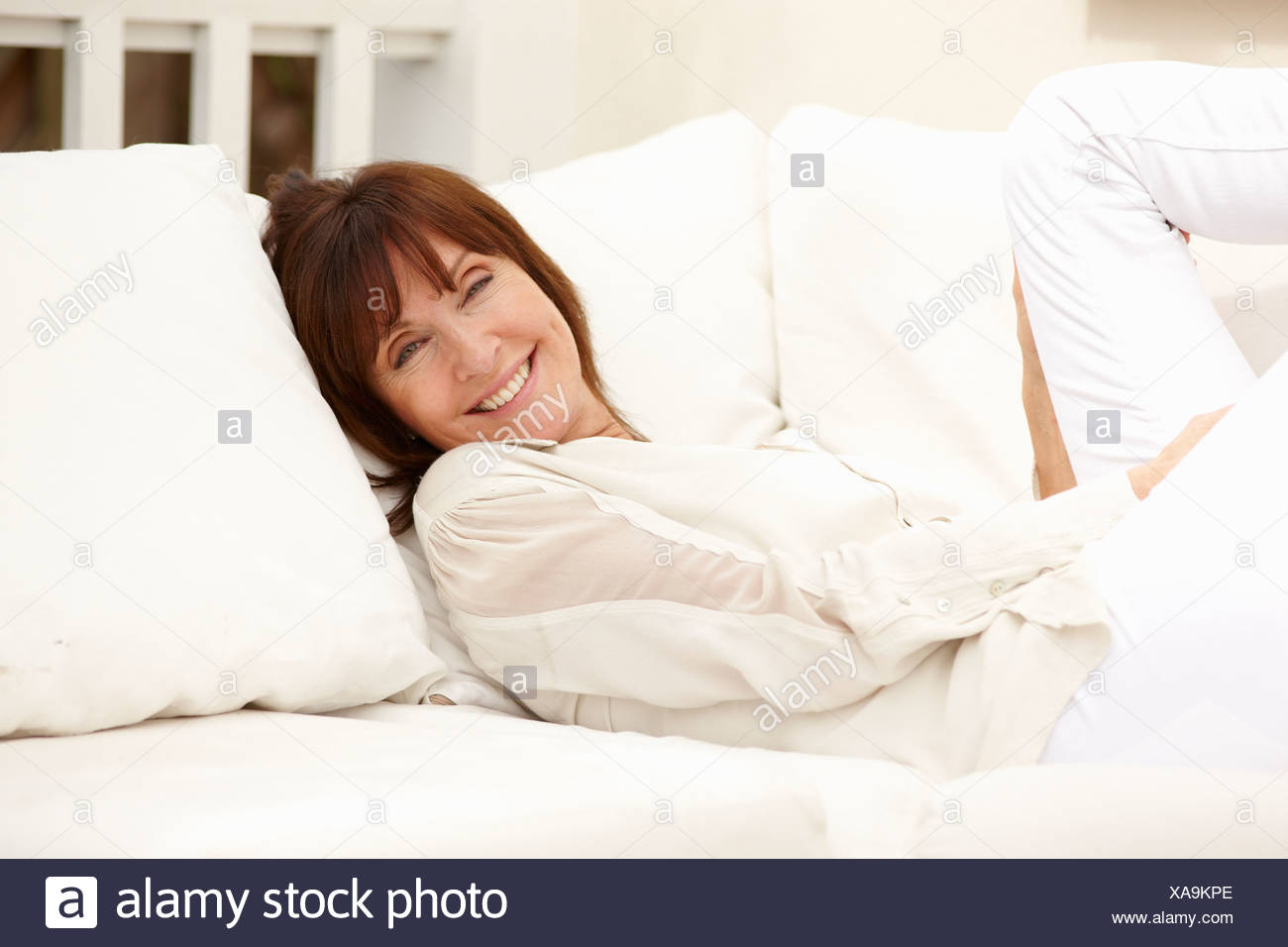 Mature Woman Reclining On Sofa Stock Photos & Mature Woman Reclining On ...