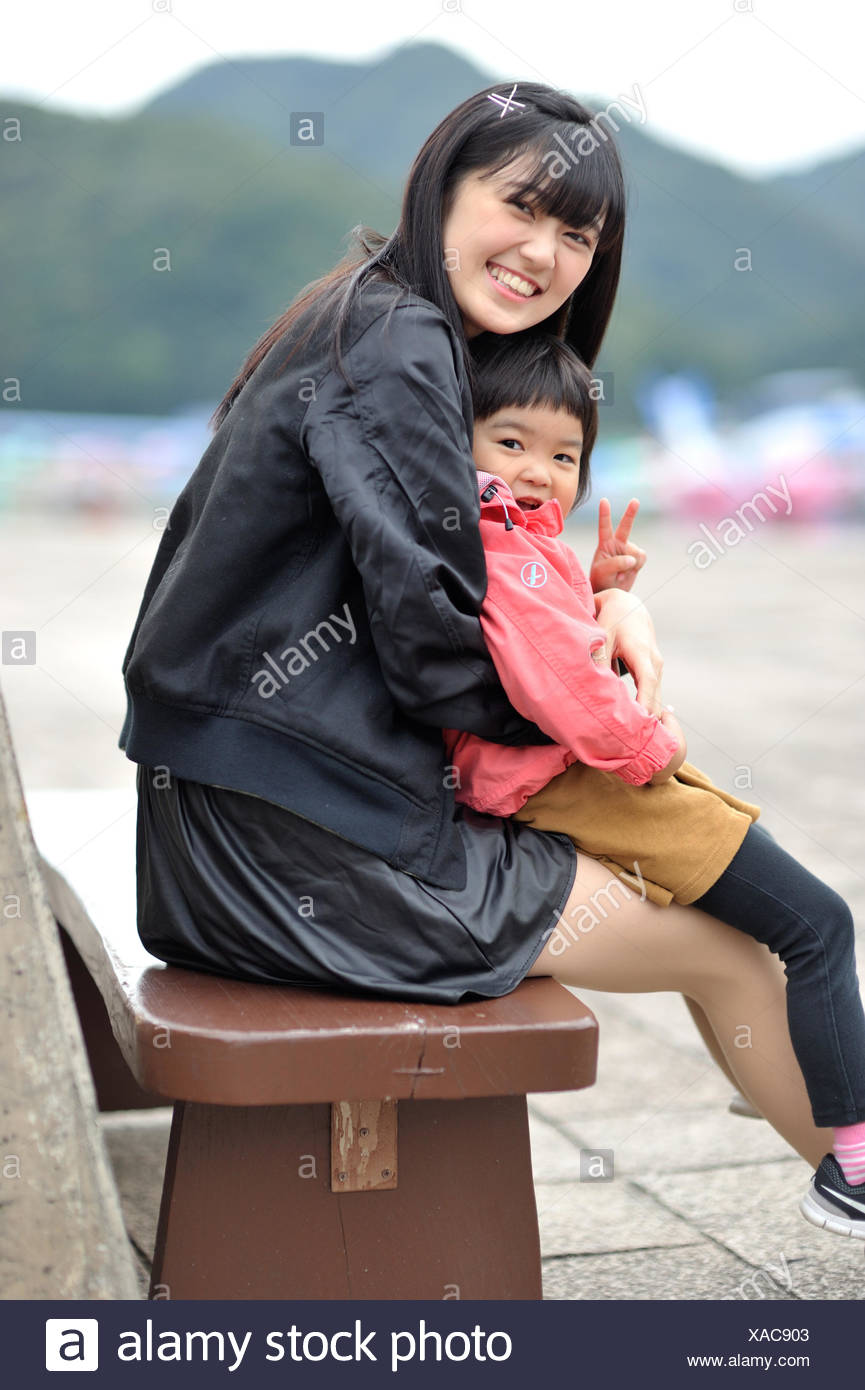 Asian Girl Sitting On Bench Stock Photos & Asian Girl Sitting On Bench ...