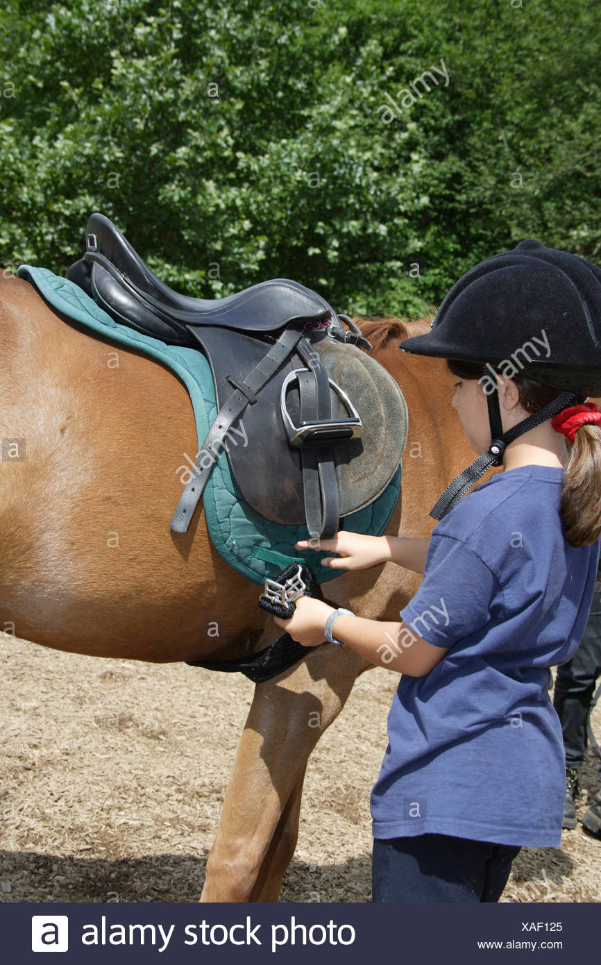 Girl Saddling Horse High Resolution Stock Photography and Images - Alamy