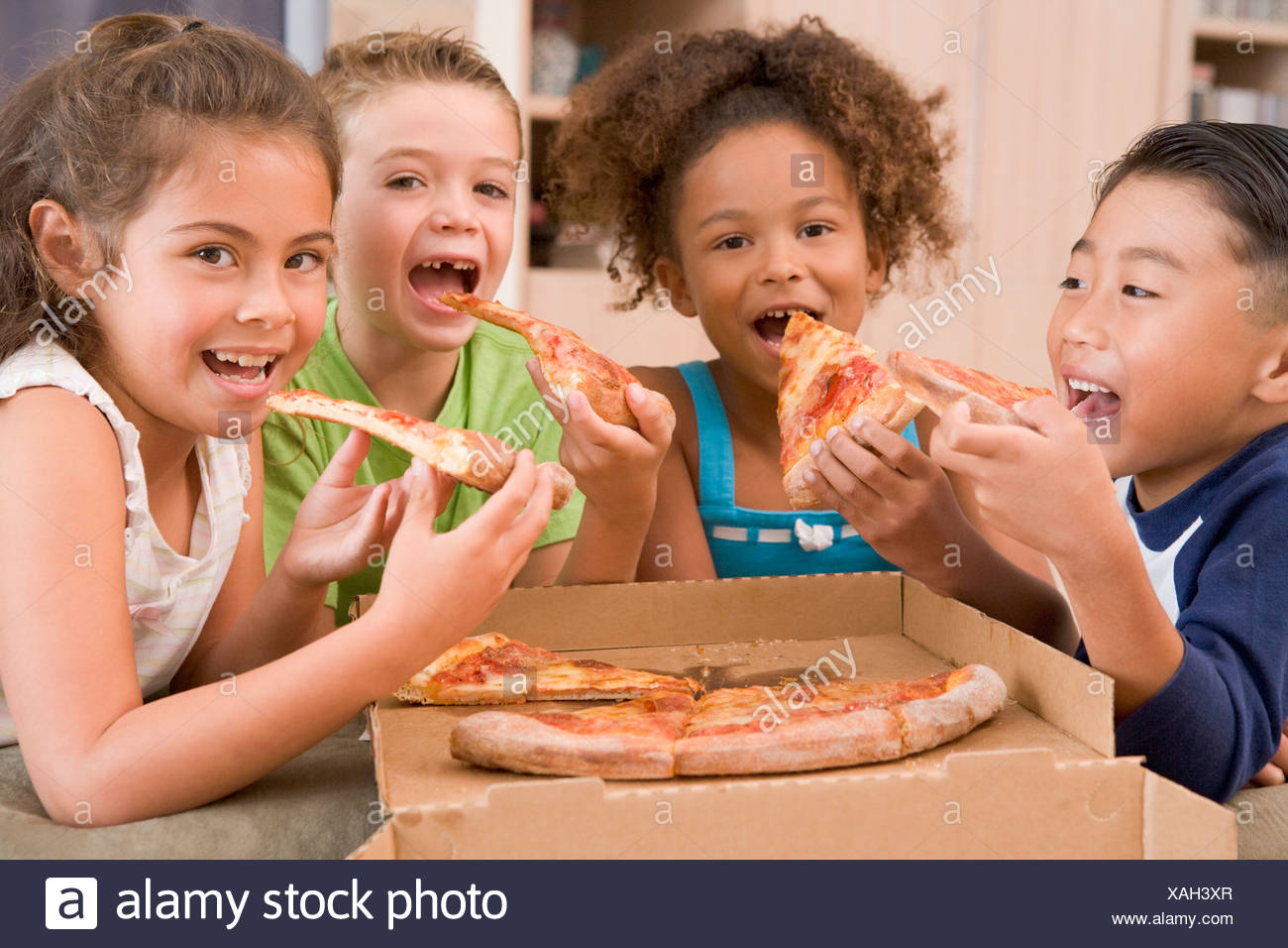 Four Friends Sharing Pizza High Resolution Stock Photography and Images ...