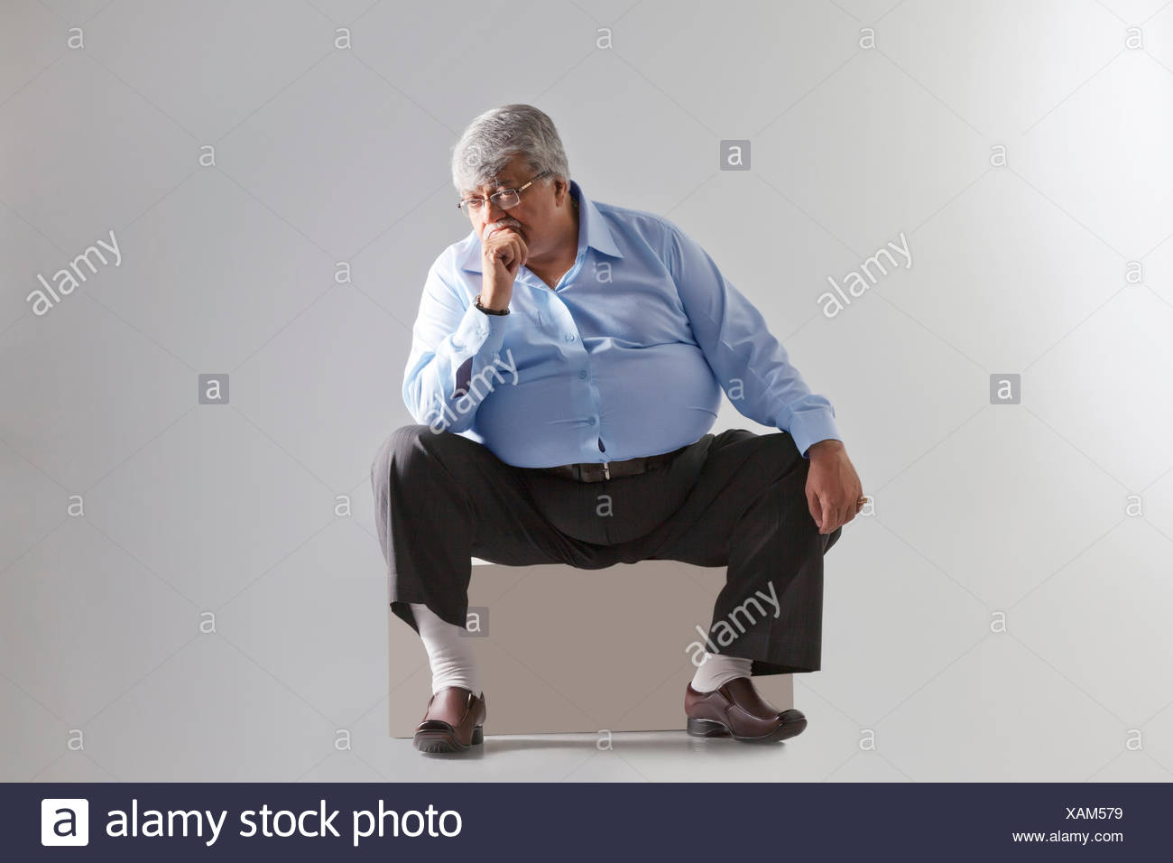 Fat Man Sitting High Resolution Stock Photography and Images - Alamy