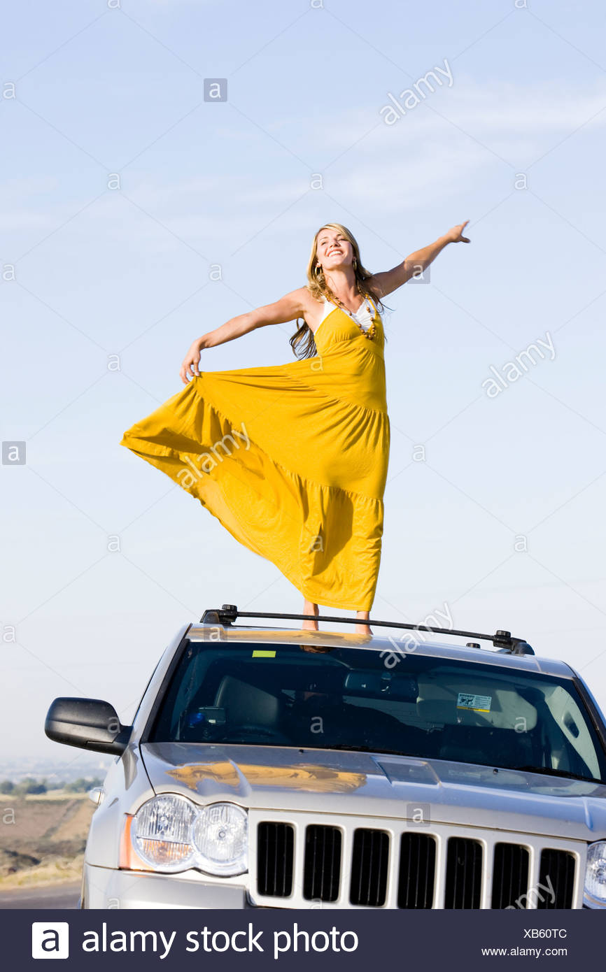 Woman Standing On Roof Car Stock Photos & Woman Standing On Roof Car ...