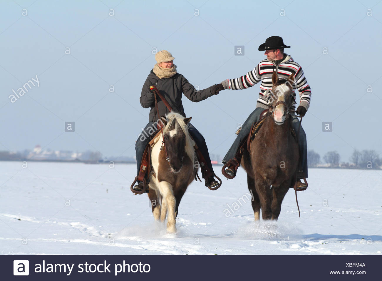 Cowboys Riding Horses In Snow High Resolution Stock Photography and ...