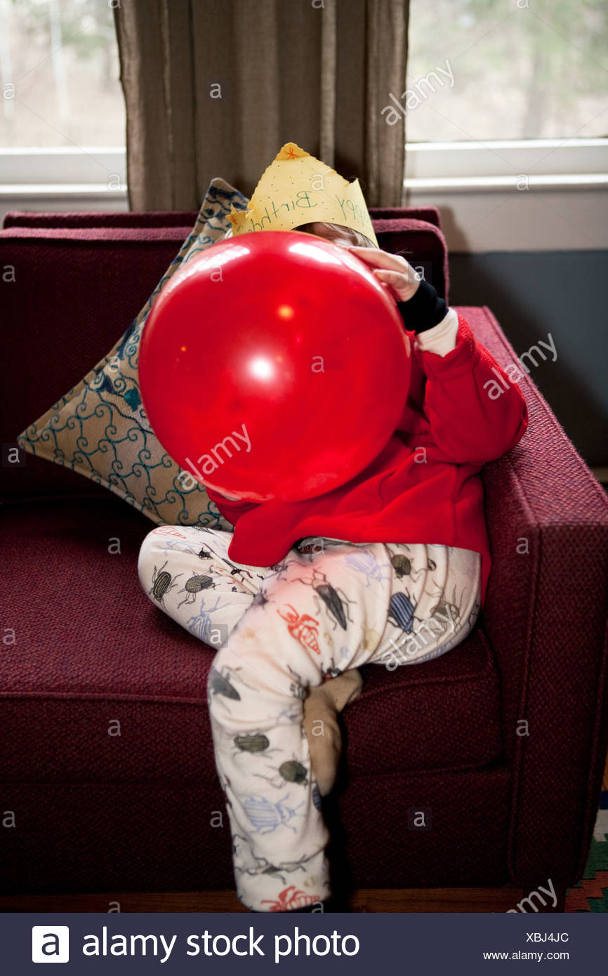 Boy Blowing Up Red Balloon High Resolution Stock Photography and Images ...