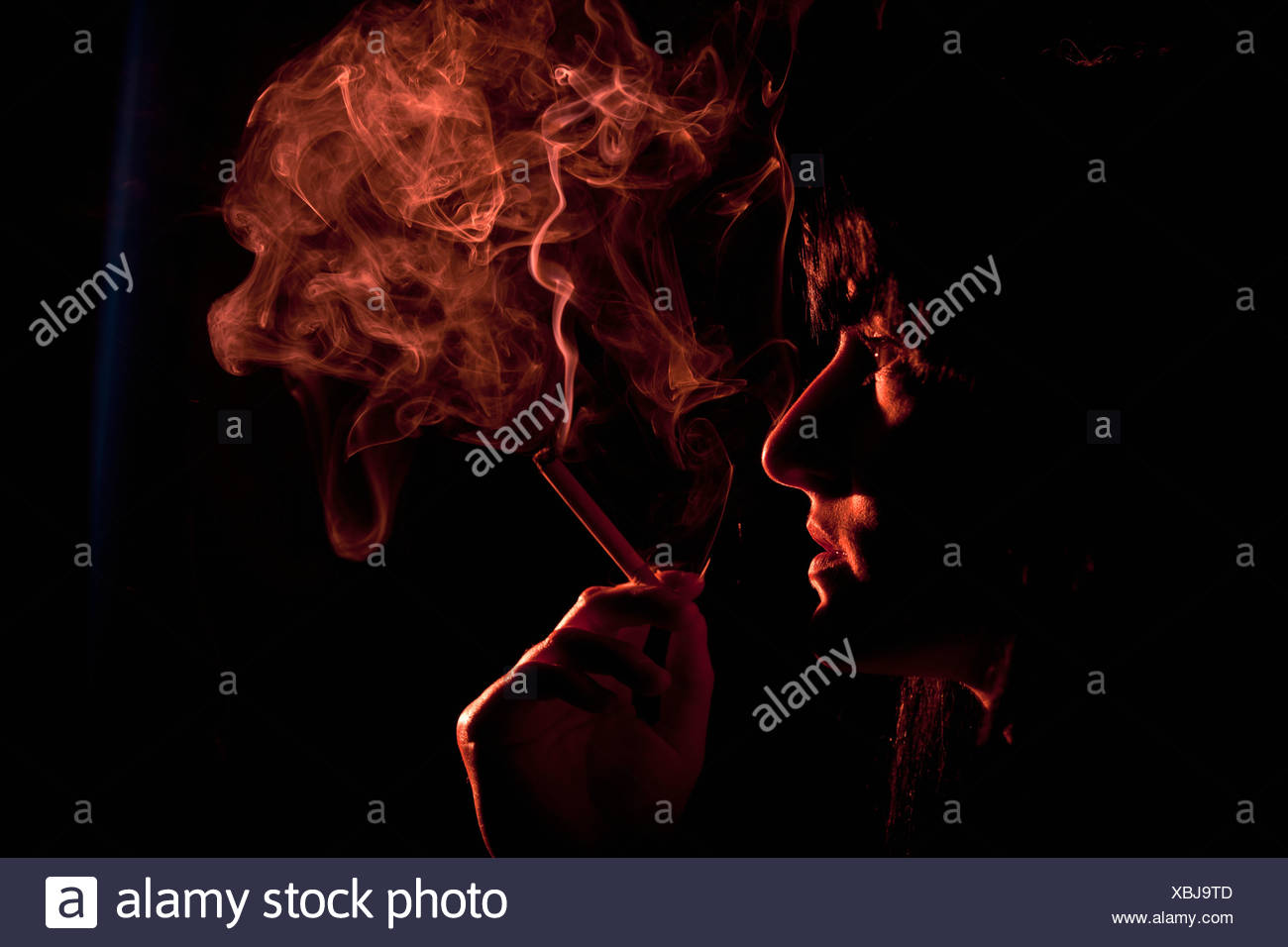 Young Woman Smoking Cigarette Inside High Resolution Stock Photography ...