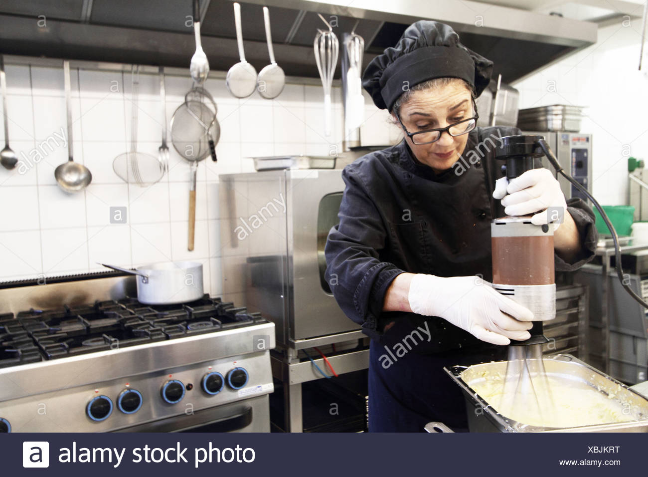 Woman Chef In Restaurant Kitchen High Resolution Stock Photography and ...