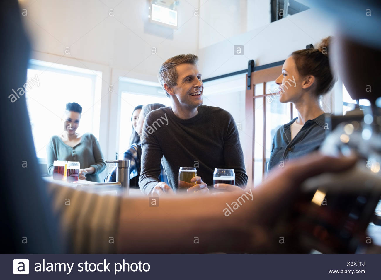 Couple Talking At Bar Standing Holding Drink Stock Photos & Couple ...