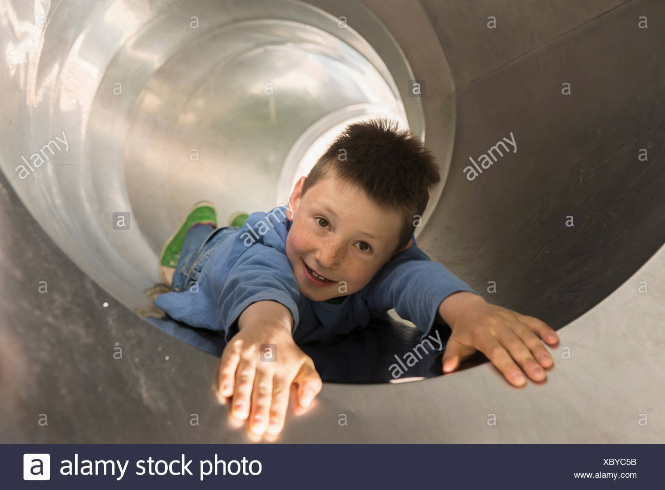 Boy Sliding Down Playground Slide High Resolution Stock Photography and ...
