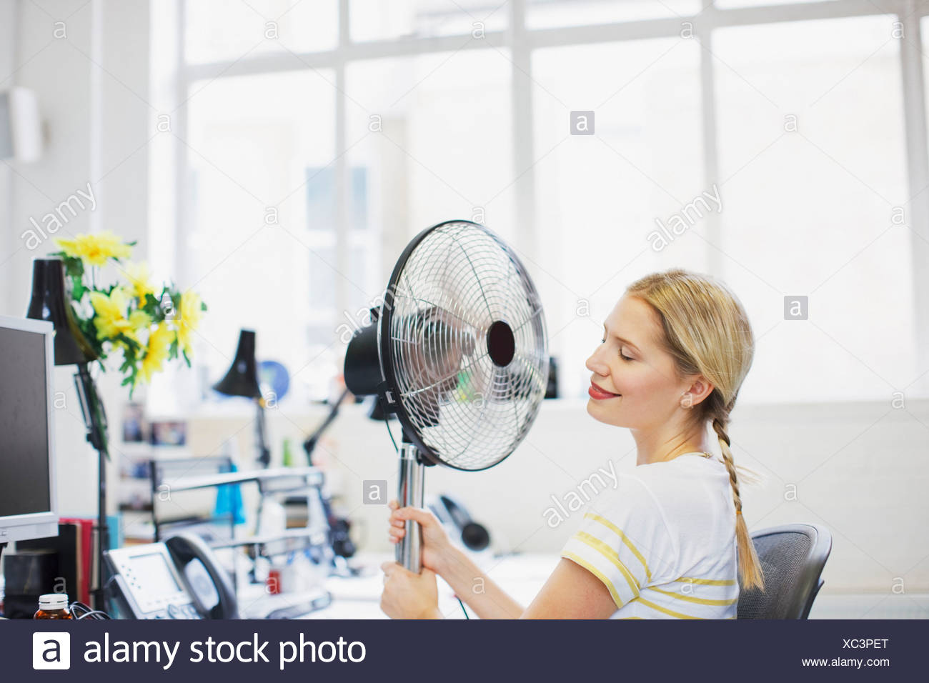 Woman Sitting In Front Of An Electric Fan Stock Photos & Woman Sitting ...