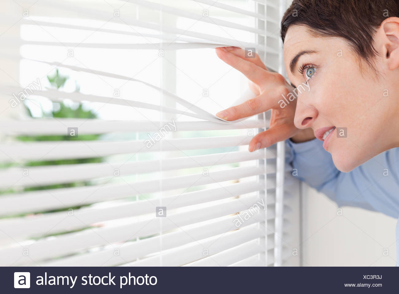 Beautiful Women Peeking Through Window Stock Photos & Beautiful Women ...
