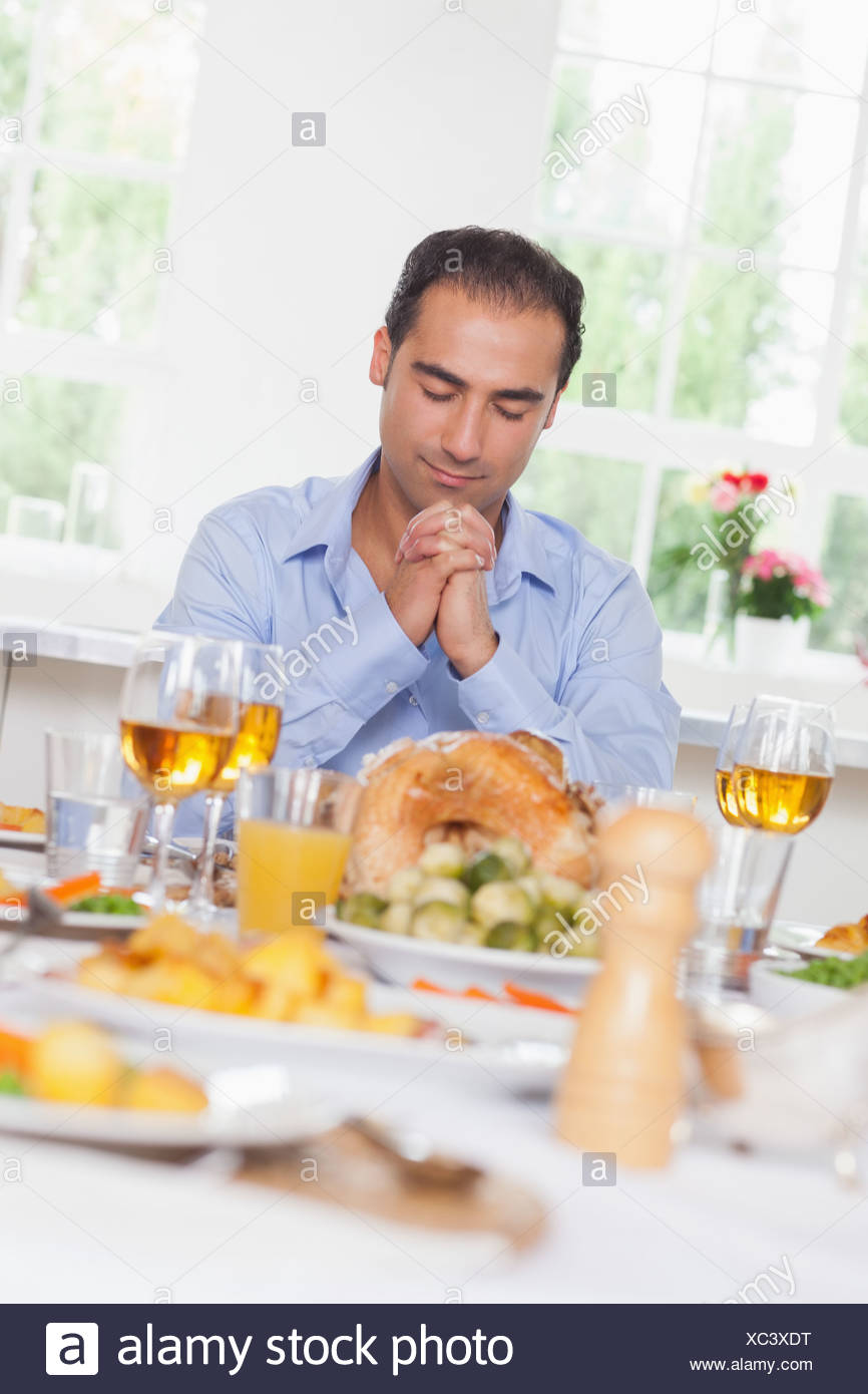 Family Saying Grace Thanksgiving Table High Resolution Stock ...