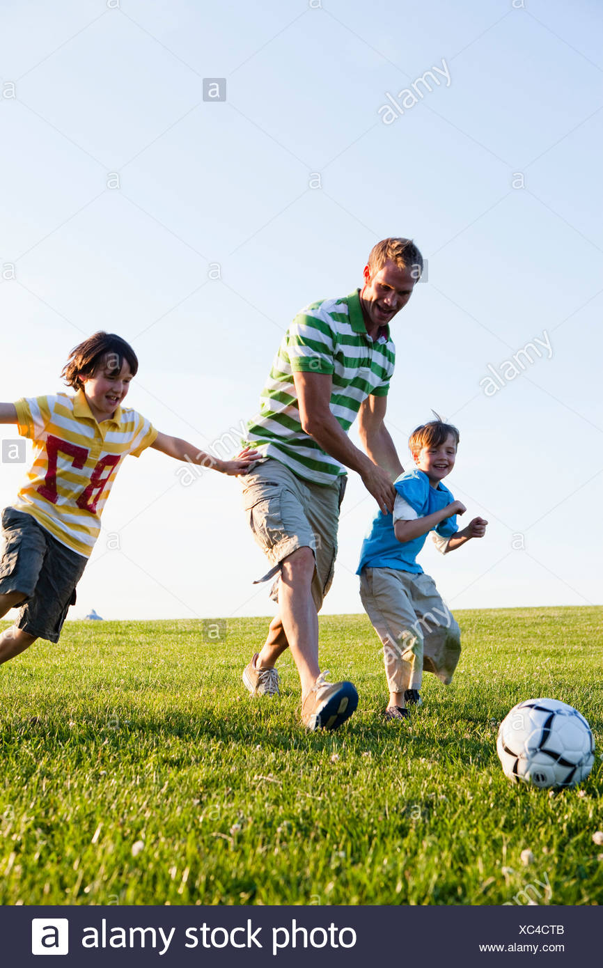 Happy Father Son Playing Football High Resolution Stock Photography and ...
