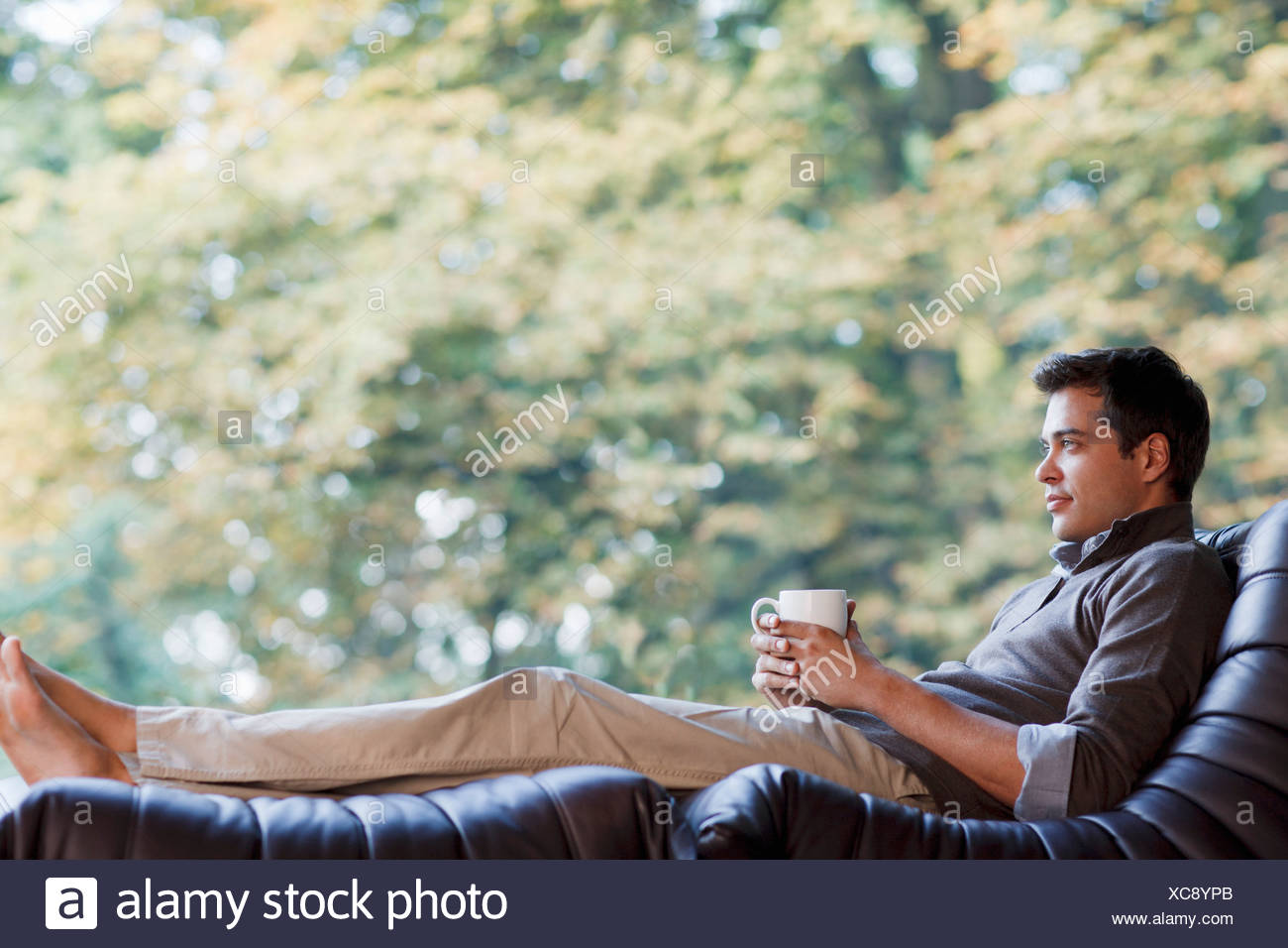 Man Laying On Lounge Chair Stock Photos & Man Laying On Lounge Chair ...