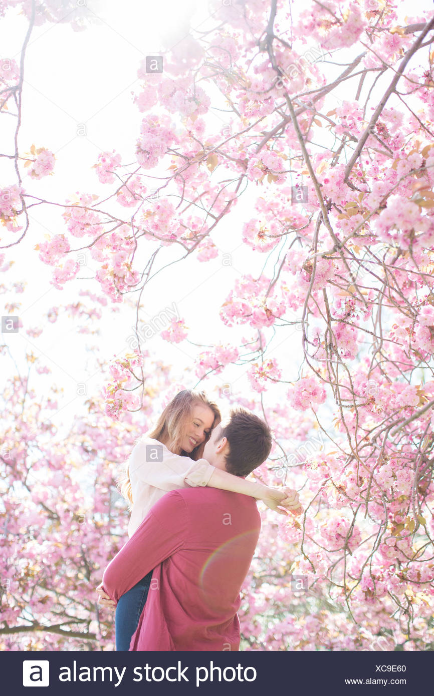 Young Couple Under Tree High Resolution Stock Photography and Images ...