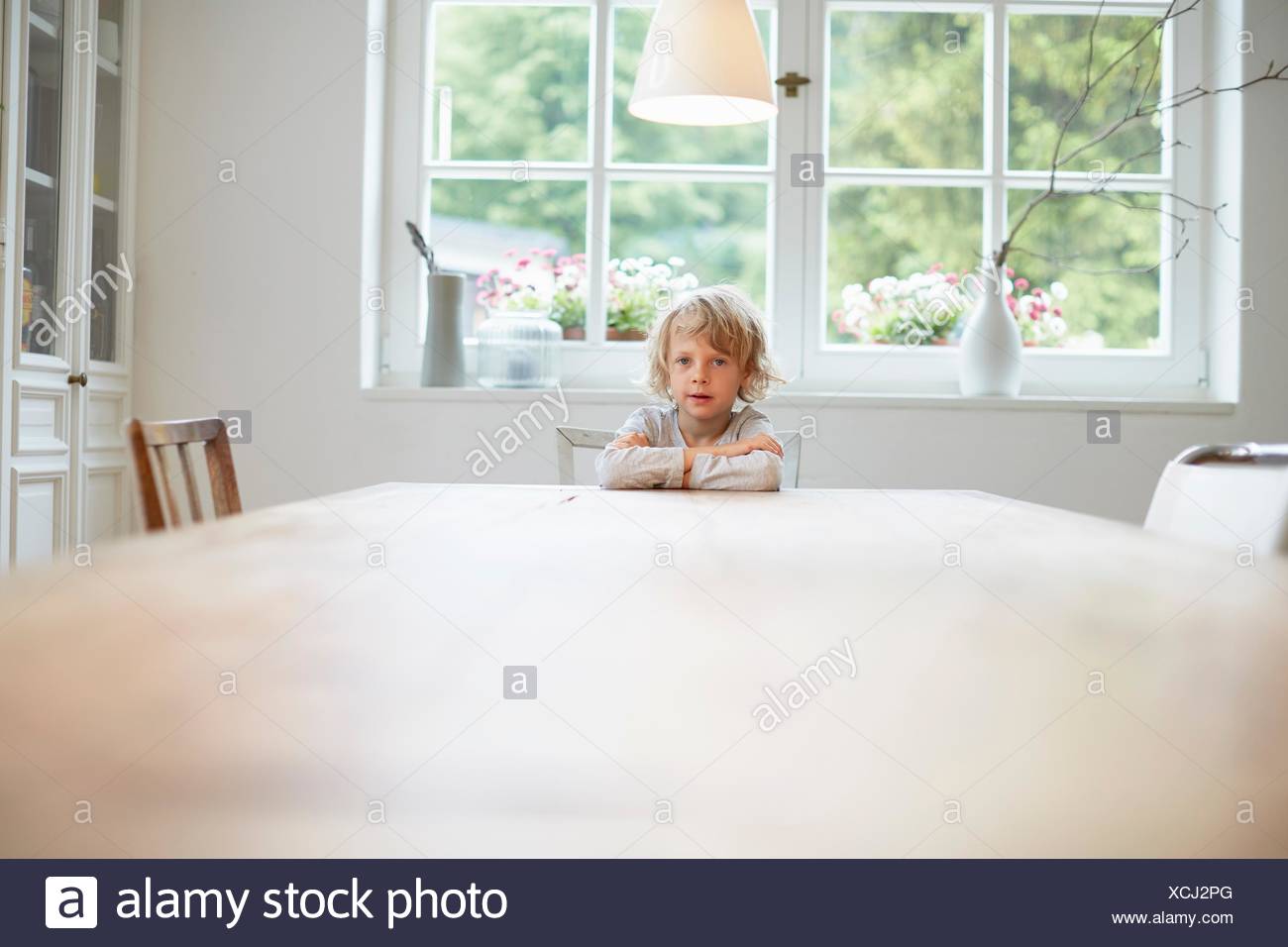 Child Sitting Table Arms Crossed High Resolution Stock Photography and ...