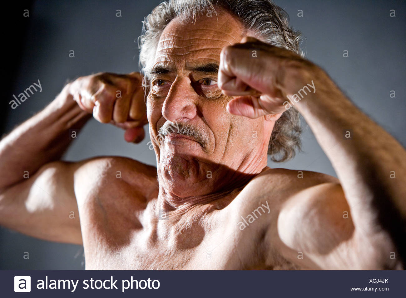 Senior Man Flexing Muscle Stock Photos & Senior Man Flexing Muscle ...