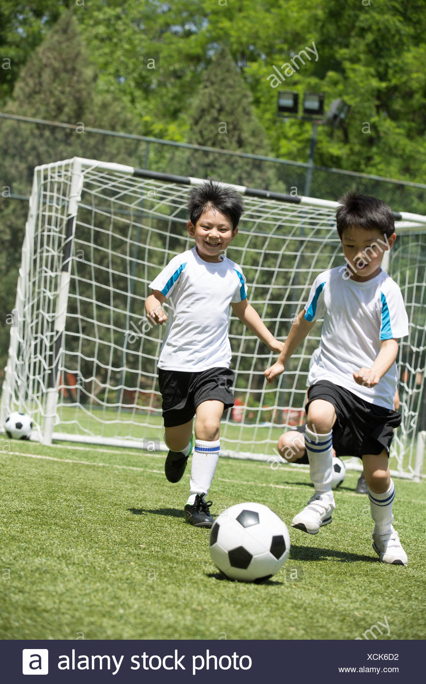 Two Boys Playing Football On Stock Photos & Two Boys Playing Football ...