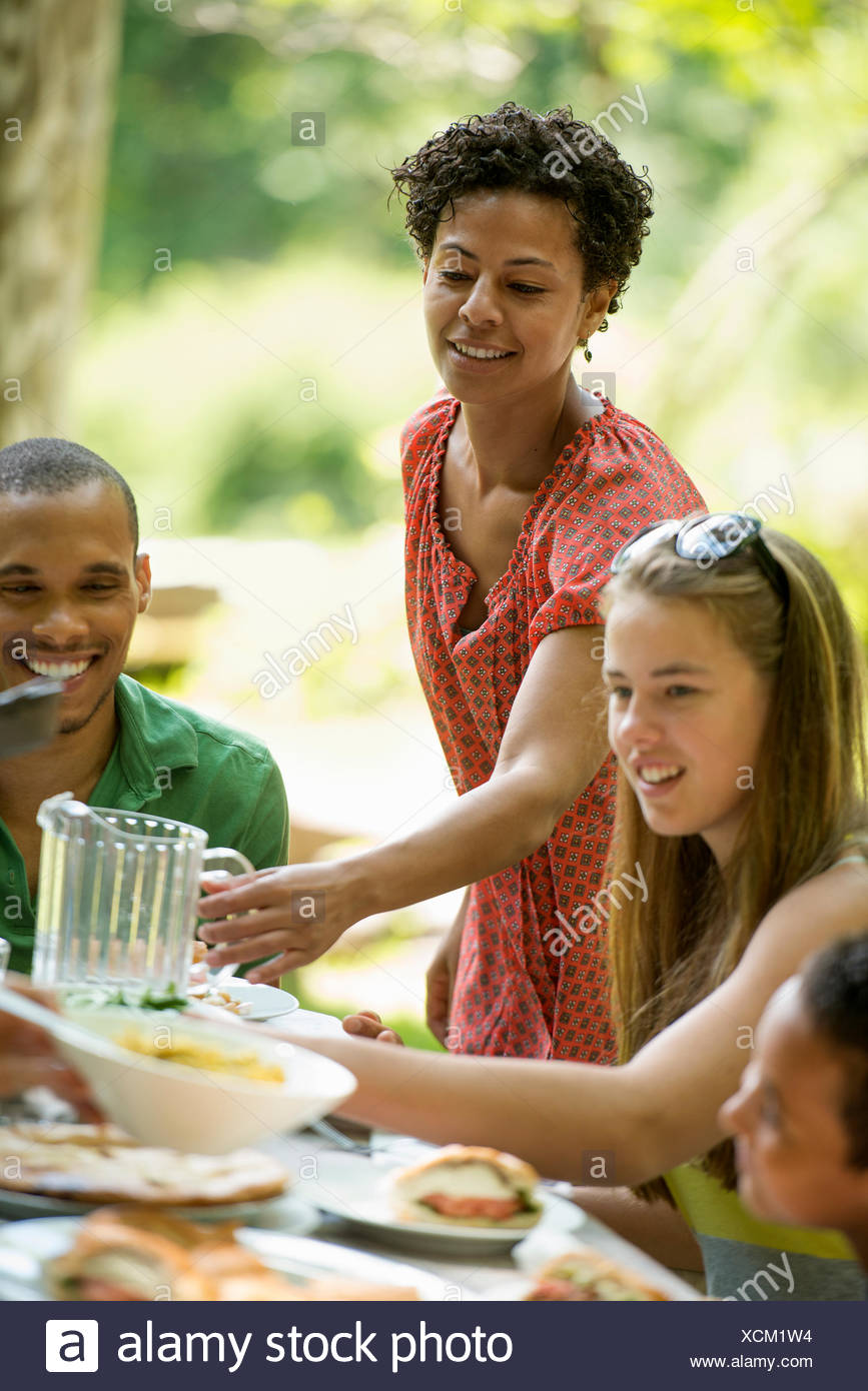 Men Women Children Around Table In Garden In Summer High Resolution ...