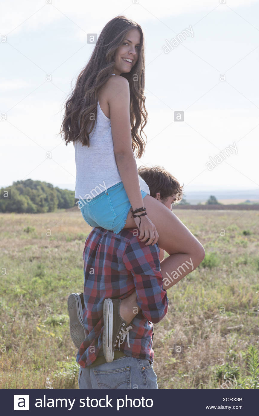 Man Shoulder Carrying Woman Stock Photos & Man Shoulder Carrying Woman ...