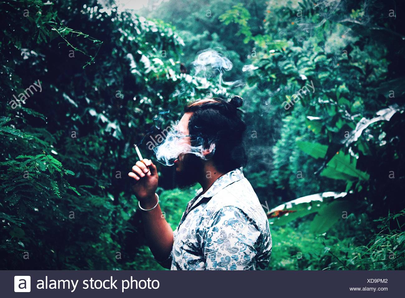 Against Tree Smoking Cigarette High Resolution Stock Photography and ...