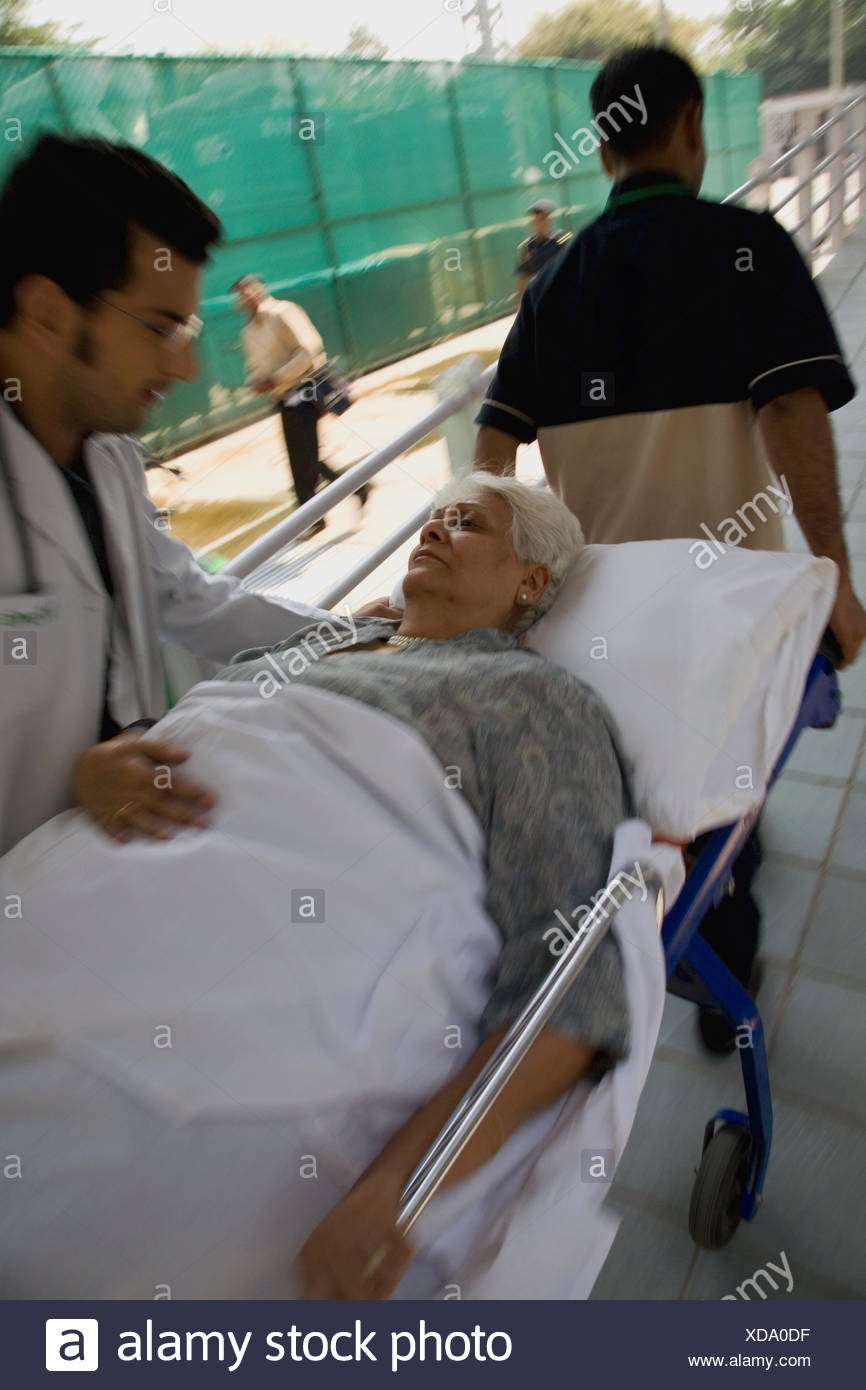 Doctor Rushing Elderly Patient Hospital High Resolution Stock ...
