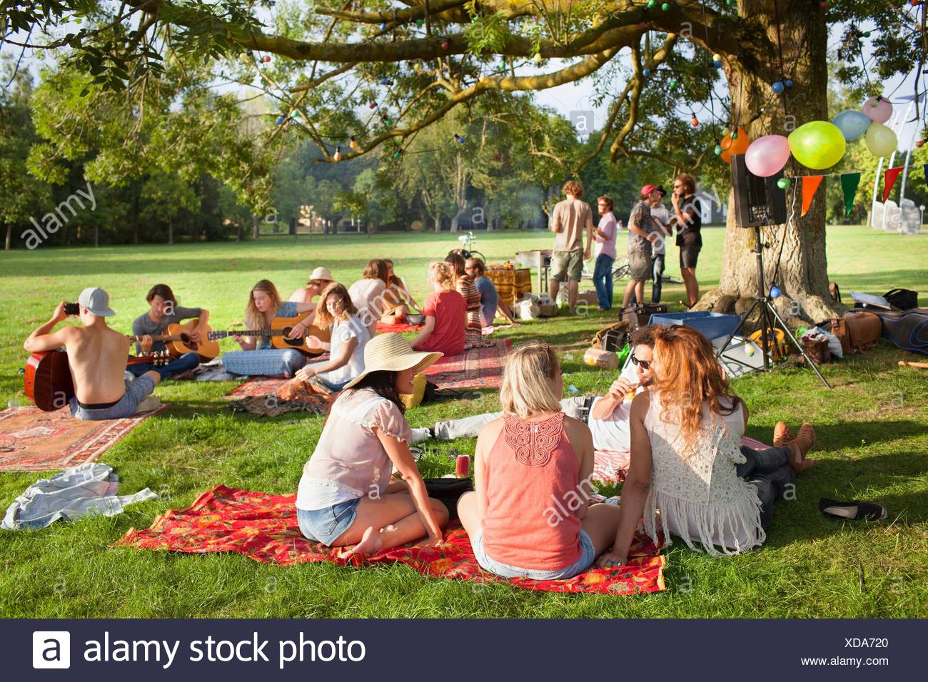 Multi Ethnic People Sitting Under Tree High Resolution Stock ...