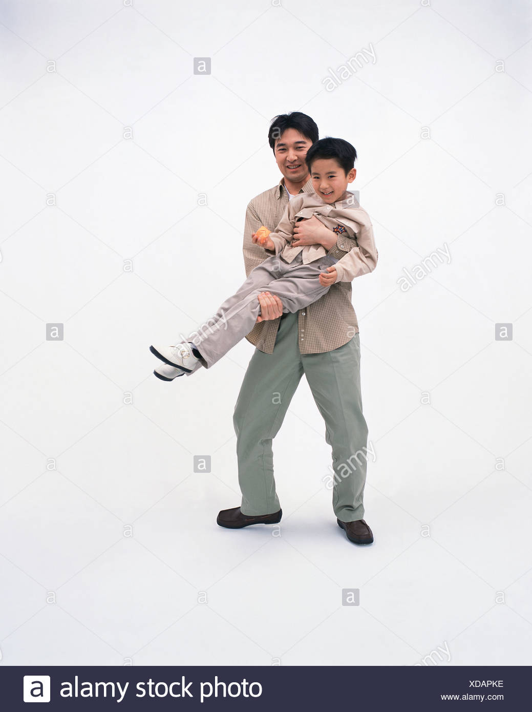 A Man Lifting A Small Boy Up High Resolution Stock Photography and ...