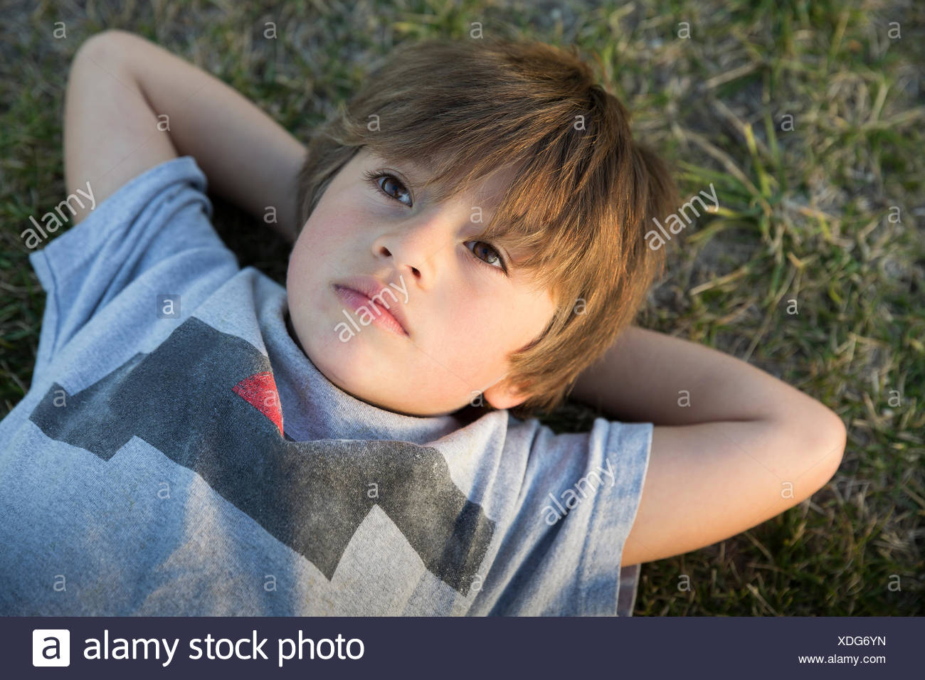 Boy Lying On Hands Behind High Resolution Stock Photography and Images ...