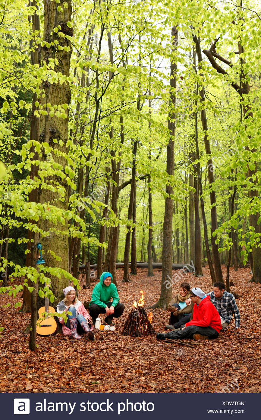 Three People Sitting Around Campfire High Resolution Stock Photography ...