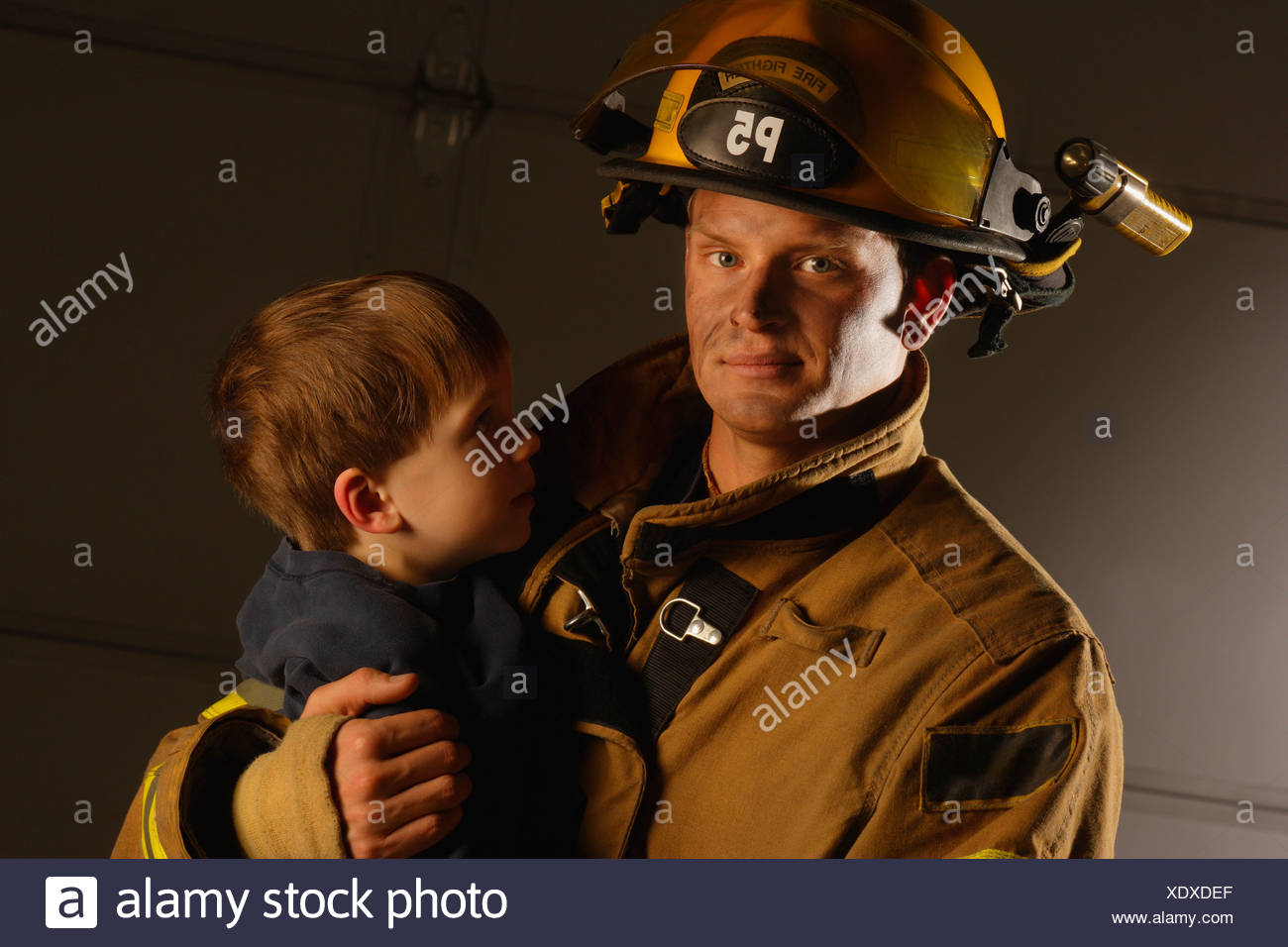 Firefighter Rescue Child Stock Photos & Firefighter Rescue Child Stock Images - Alamy