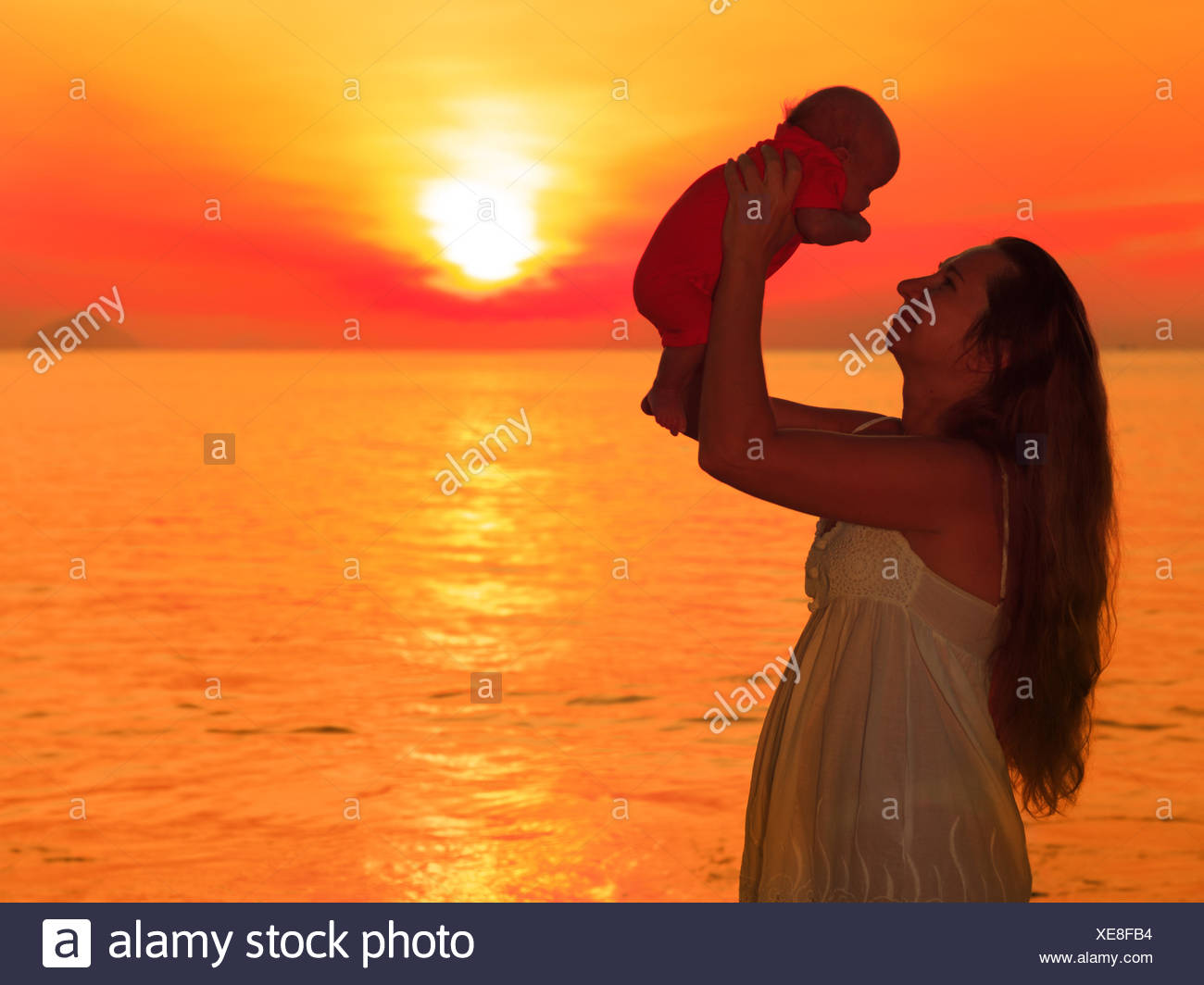 Mother Holding Baby Silhouette Stock Photos & Mother Holding Baby ...