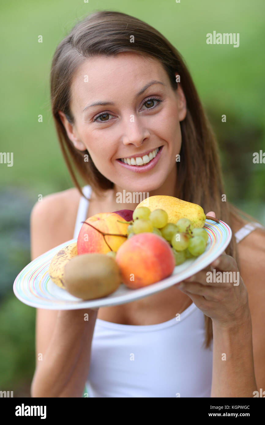 Portrait of beautiful girl holding fresh fruits Stock Photo - Alamy