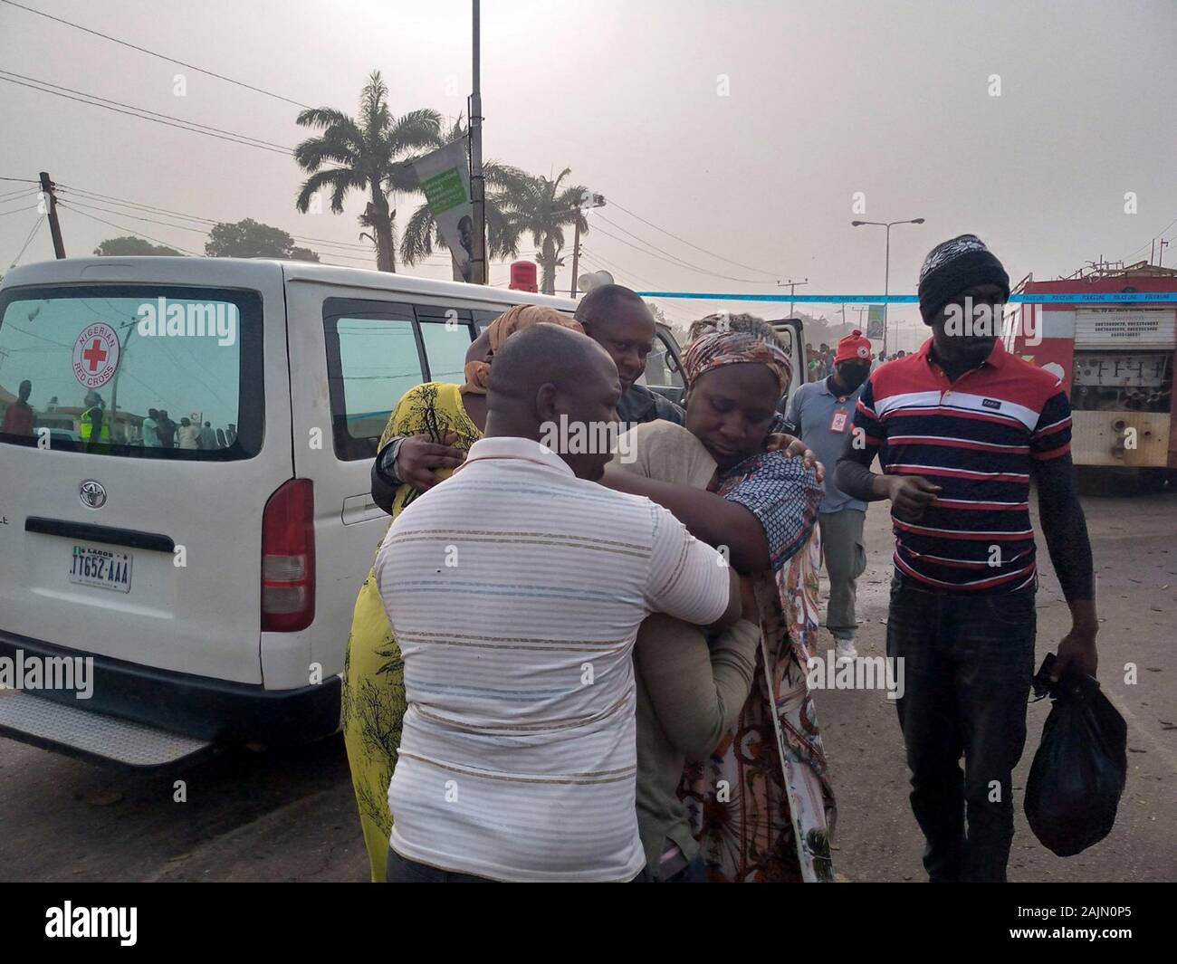 Kaduna, Nigeria. 04 Jan, 2020. Menschen umarmen sich in der Szene von einer Gasexplosion in ...