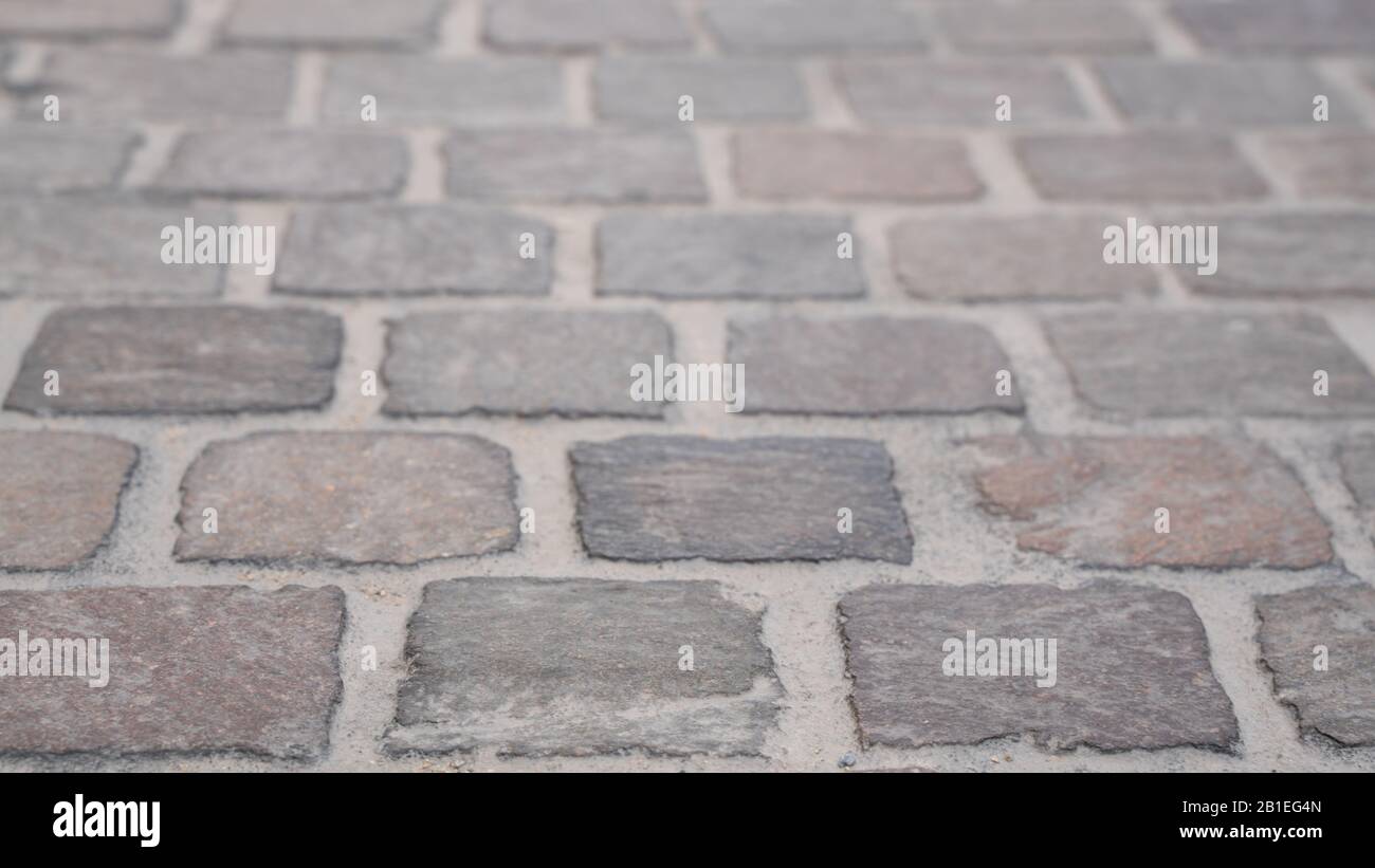 Hintergrundbild der Straße aus Stein aus Granit. Leichter Bürgersteig ...
