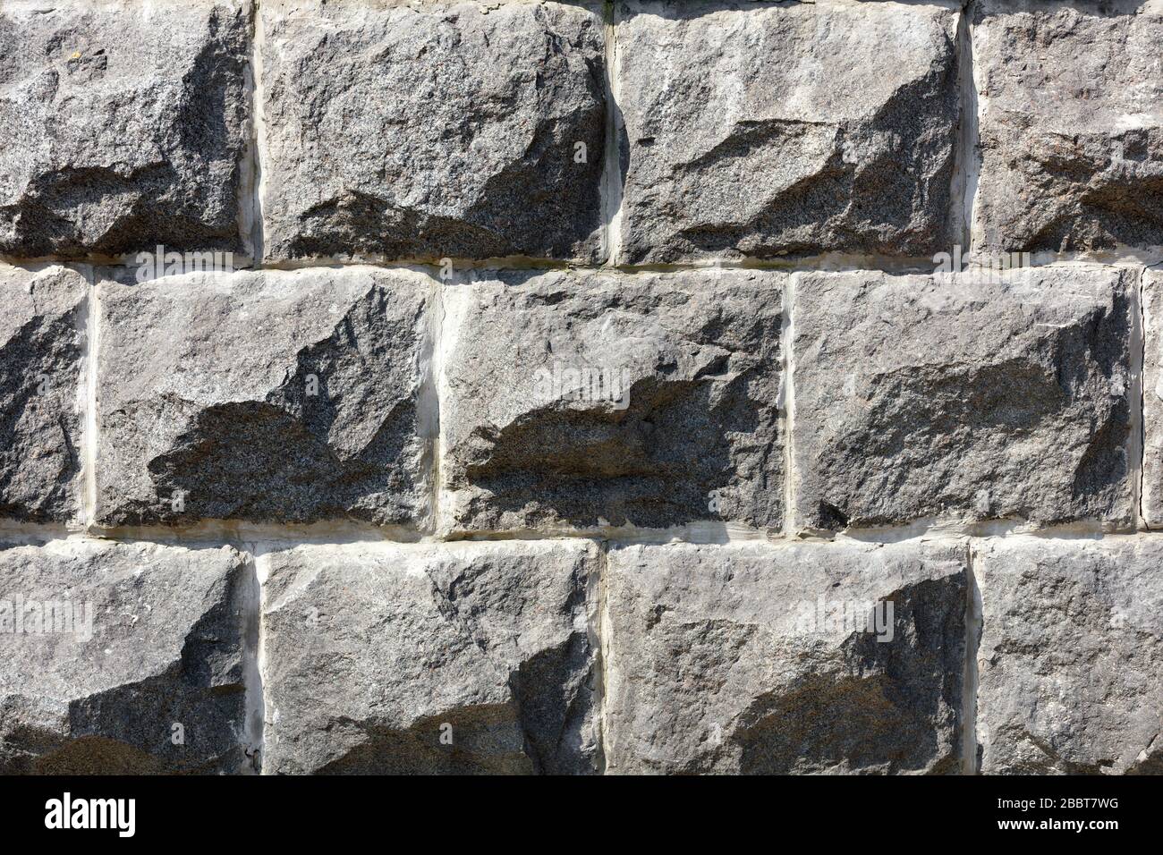 Die Textur der alten Steinmauer. Steine aus grauem Granit, als ...