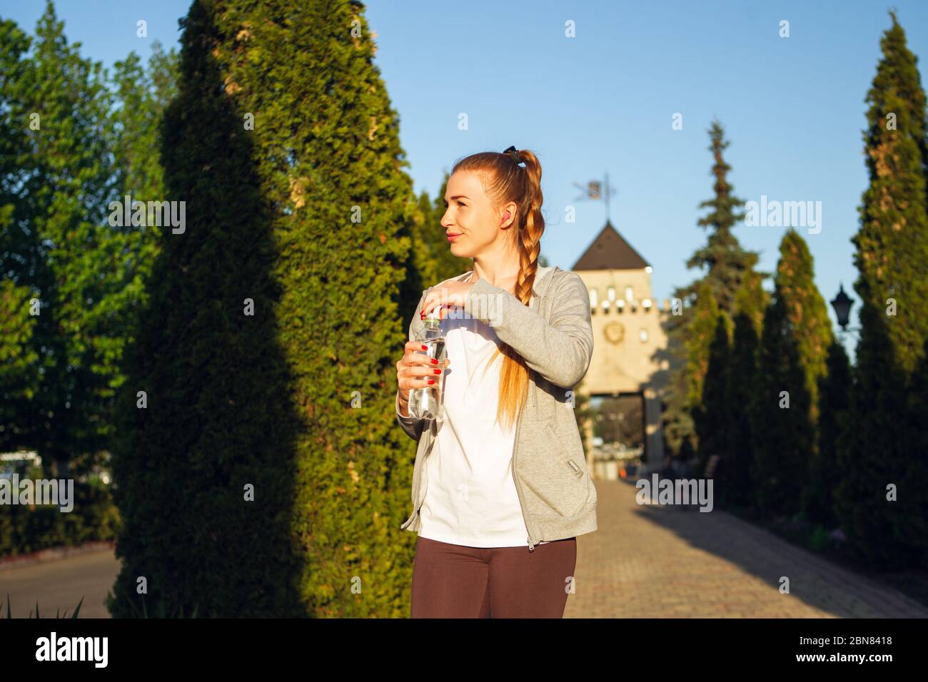 Junge Läuferin, Athletin, die sich nach dem Joggen in der Stadtstraße ... Junge Läuferin, Athletin, die sich nach dem Joggen in der Stadtstraße ...