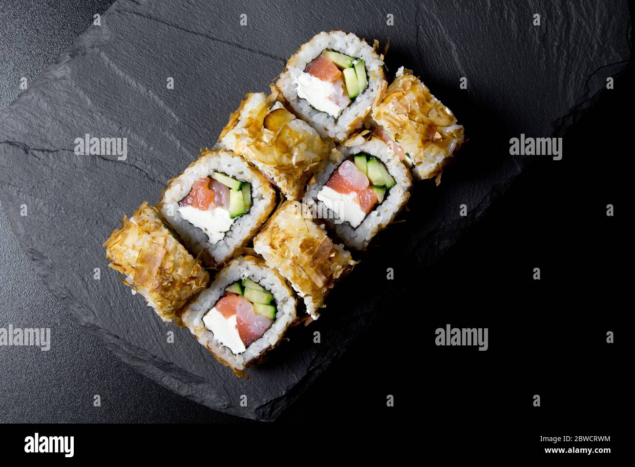 Sushi Bonito Rolle auf dunklem Hintergrund. Von oben gesehen Sushi ...