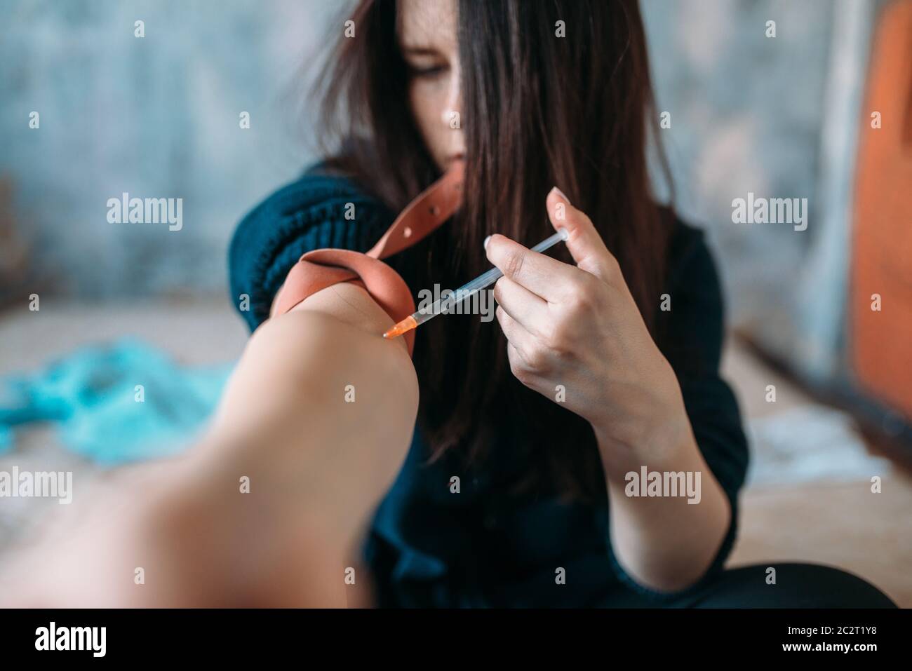 Weibliche Junkie mit einer Spritze, einer Injektion die Dosis in den ...