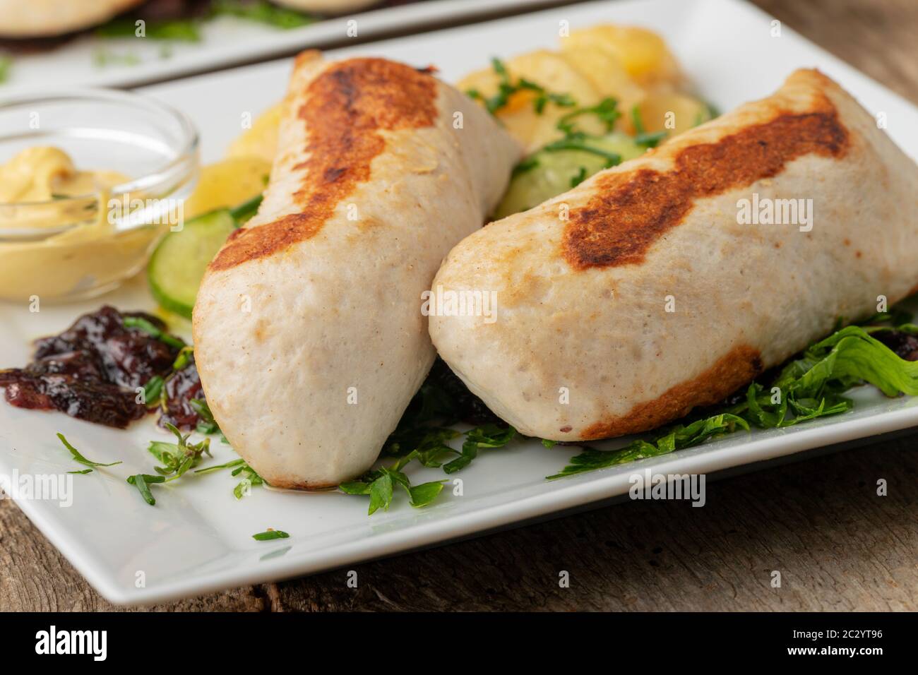 Bayerische wollwurst vom Grill mit Kartoffelsalat Stockfotografie - Alamy