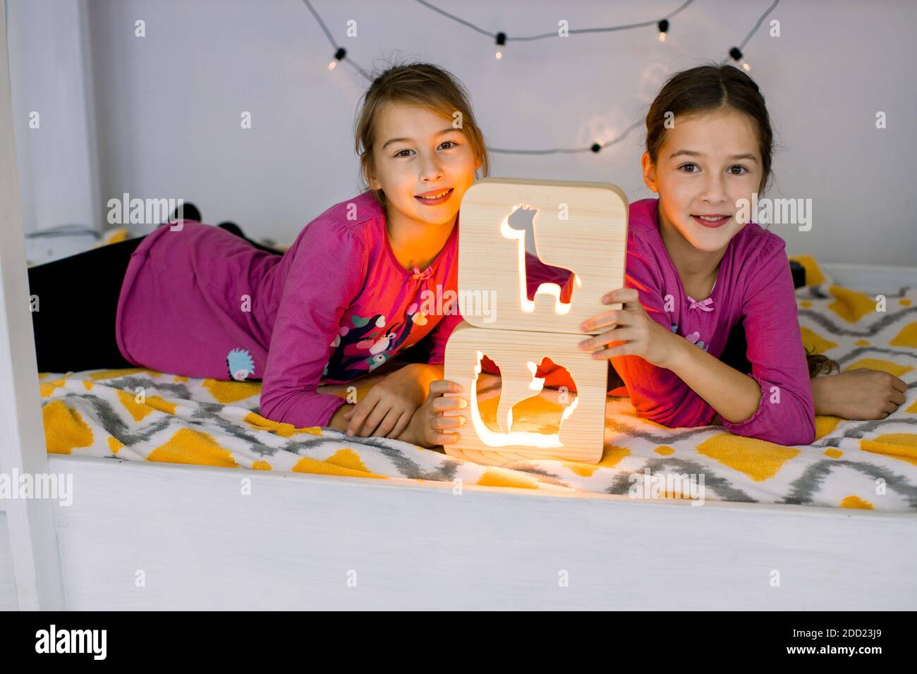 Zwei süße kaukasische Kinder, hübsche kleine Mädchen Schwestern, tragen ...