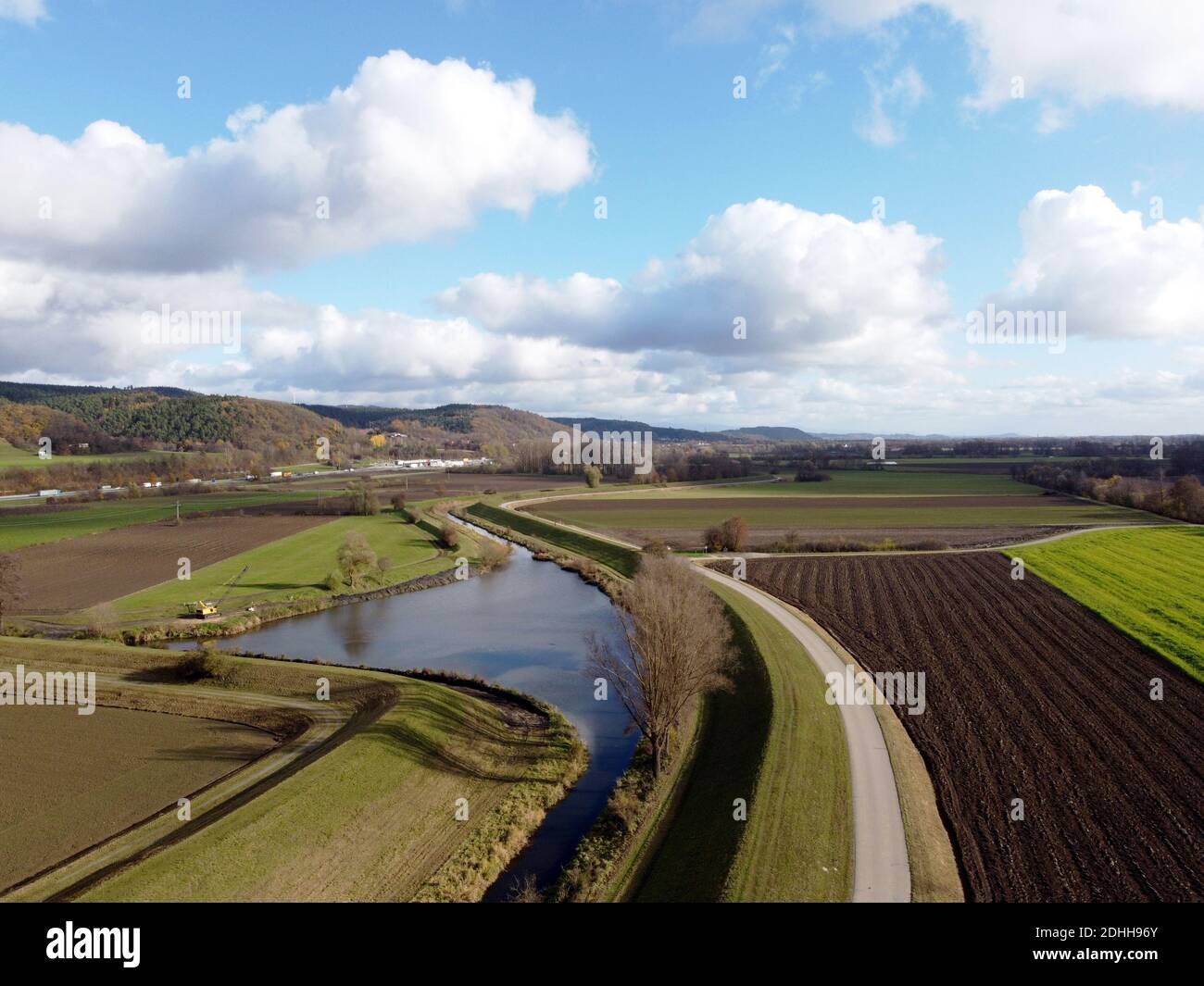 Ein Luftbild von einem schönen Land mit landwirtschaftlichen Feldern Unter den flauschigen ...