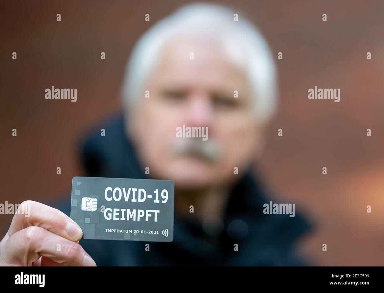 Älterer Mann mit einem deutschen Impfpass, der auf eine Impfung gegen ... Älterer Mann mit einem deutschen Impfpass, der auf eine Impfung gegen ...