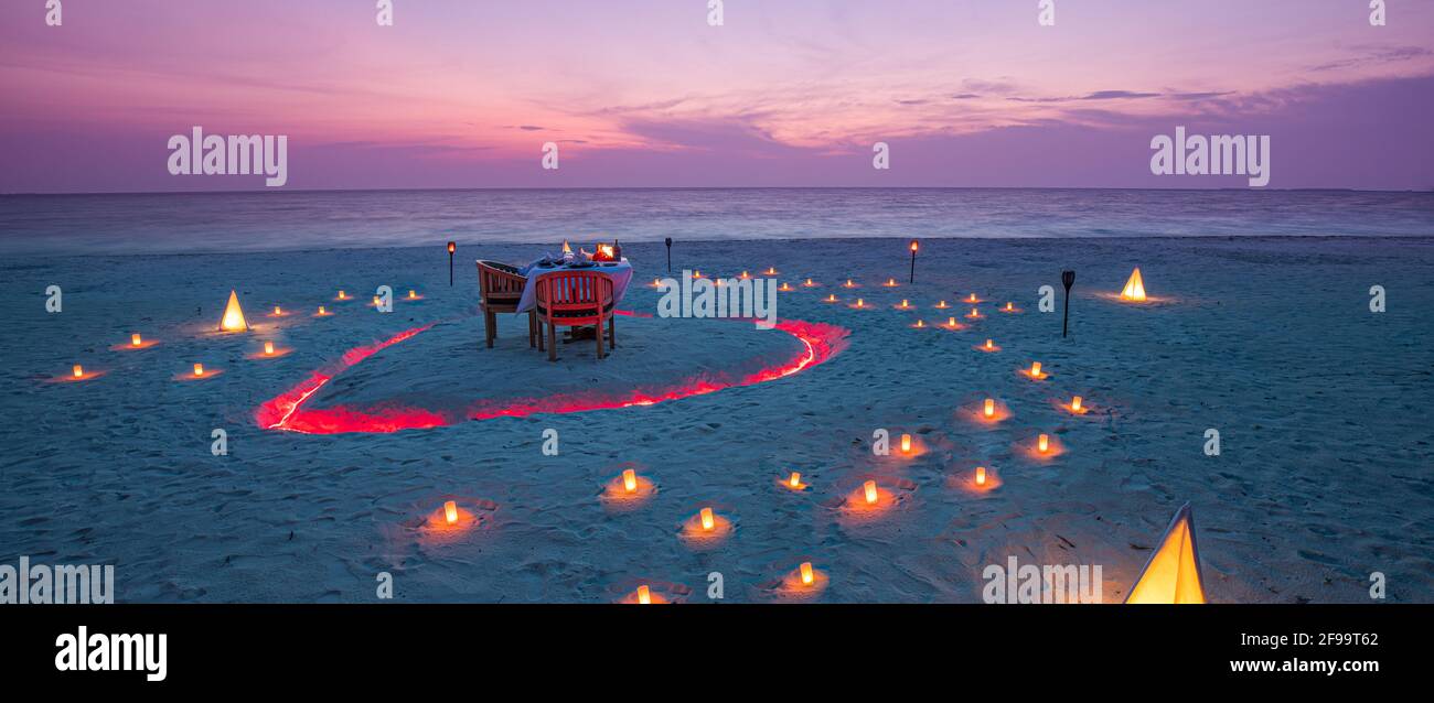 Tolles romantisches Abendessen am Strand auf der Holzterrasse mit ...