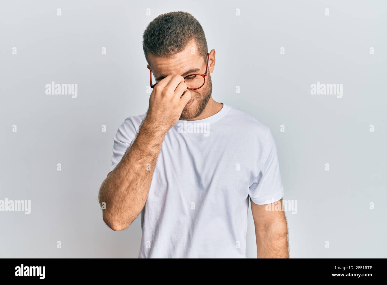 Junge kaukasischen Mann trägt Freizeitkleidung und Brille müde Reiben ...