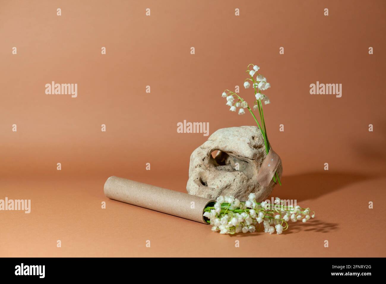 Modernes Stillleben mit ungewöhnlichem Naturstein mit Blumenstrauß aus ...